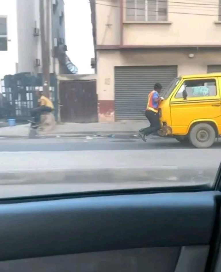 Policeman clings to the bonnet of a Danfo bus, as the driver speeds off ...