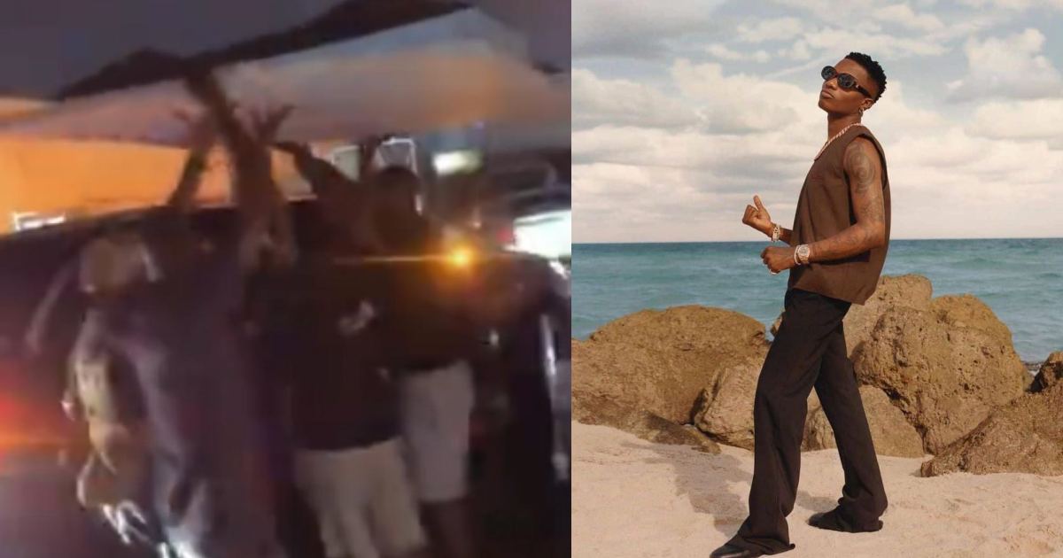 Reactions as men seen shielding Wizkid from rain with plank
